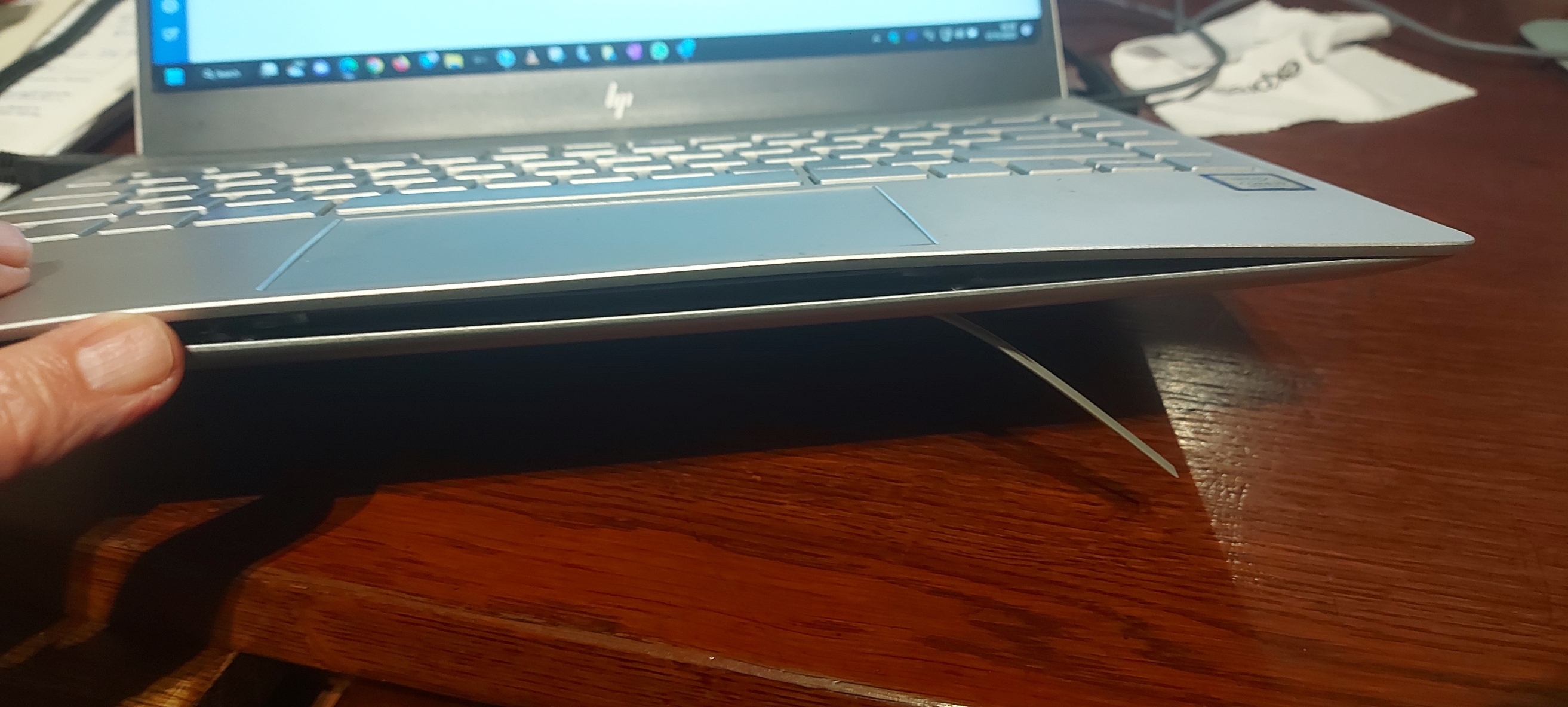 my laptop is slowly opening up. Just below the trackpad at t... - HP ...