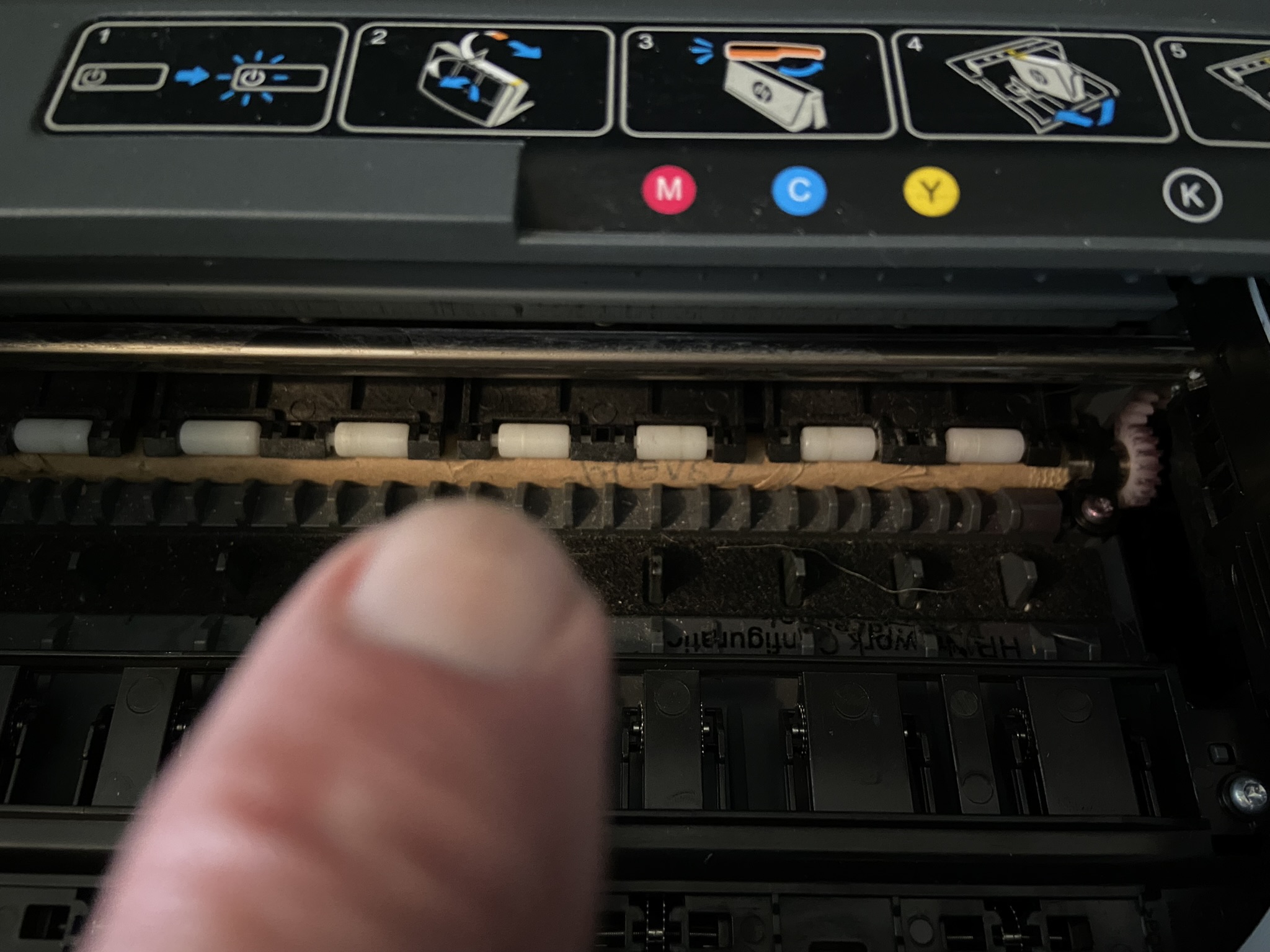 Paper wrappped around one of the feed rollers inside printer - HP ...